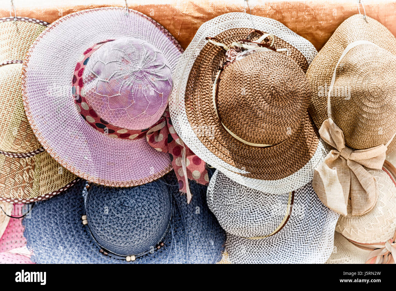 in a old market lots of colorated hats like background clothes Stock ...