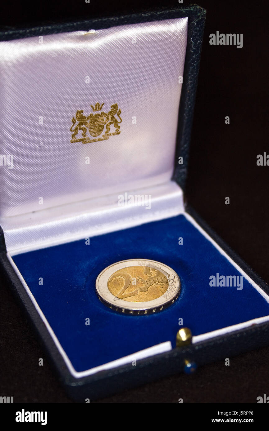 euro coin in a box Stock Photo - Alamy