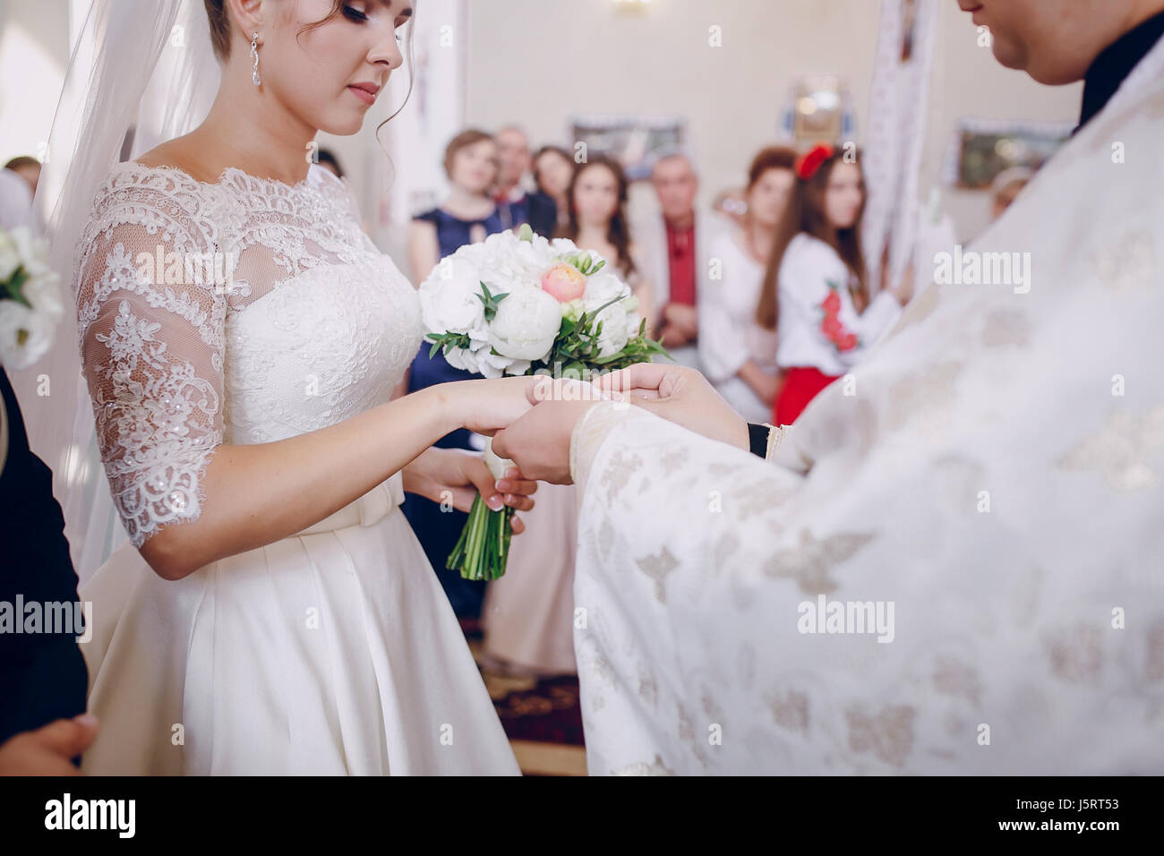 the bride and groom marry in the Church Stock Photo - Alamy