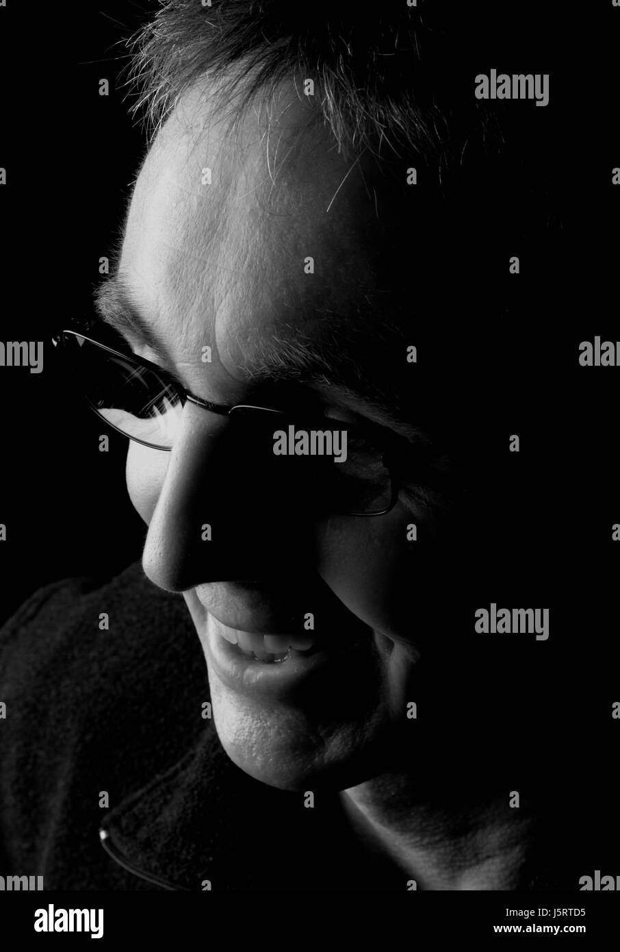 Man in shadow smiling Black and White Stock Photos & Images - Alamy