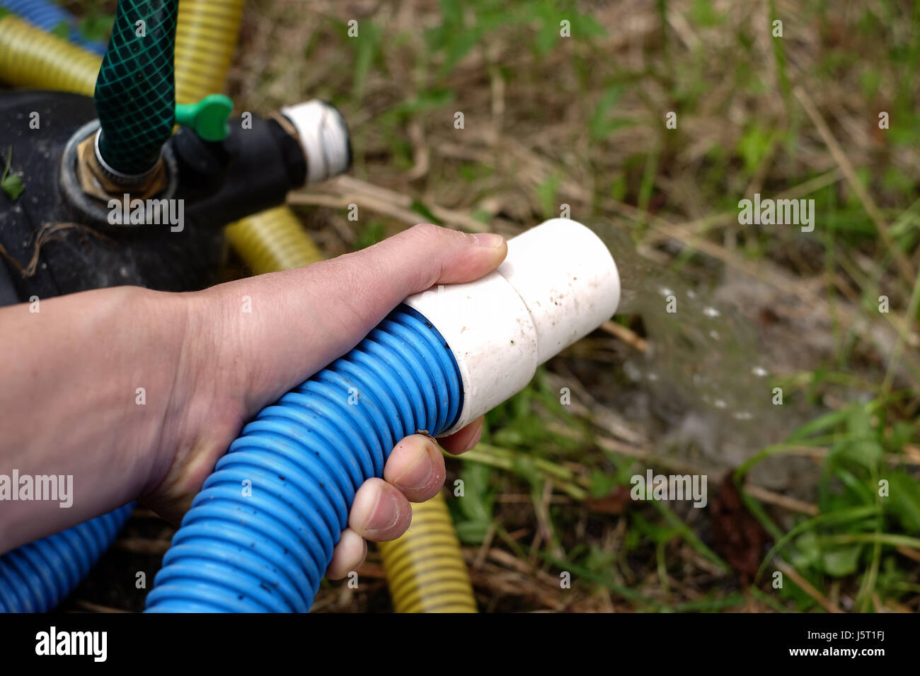 Hand With Water Hose Stock Photo - Alamy