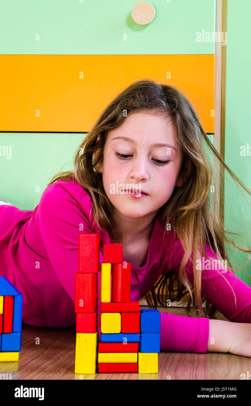 Little girl playing with construction toy blocks Stock Photo - Alamy