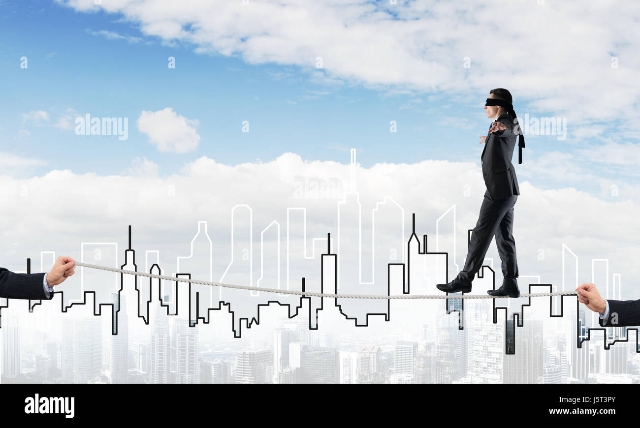 Business concept of risk support and assistance with man balancing on ...