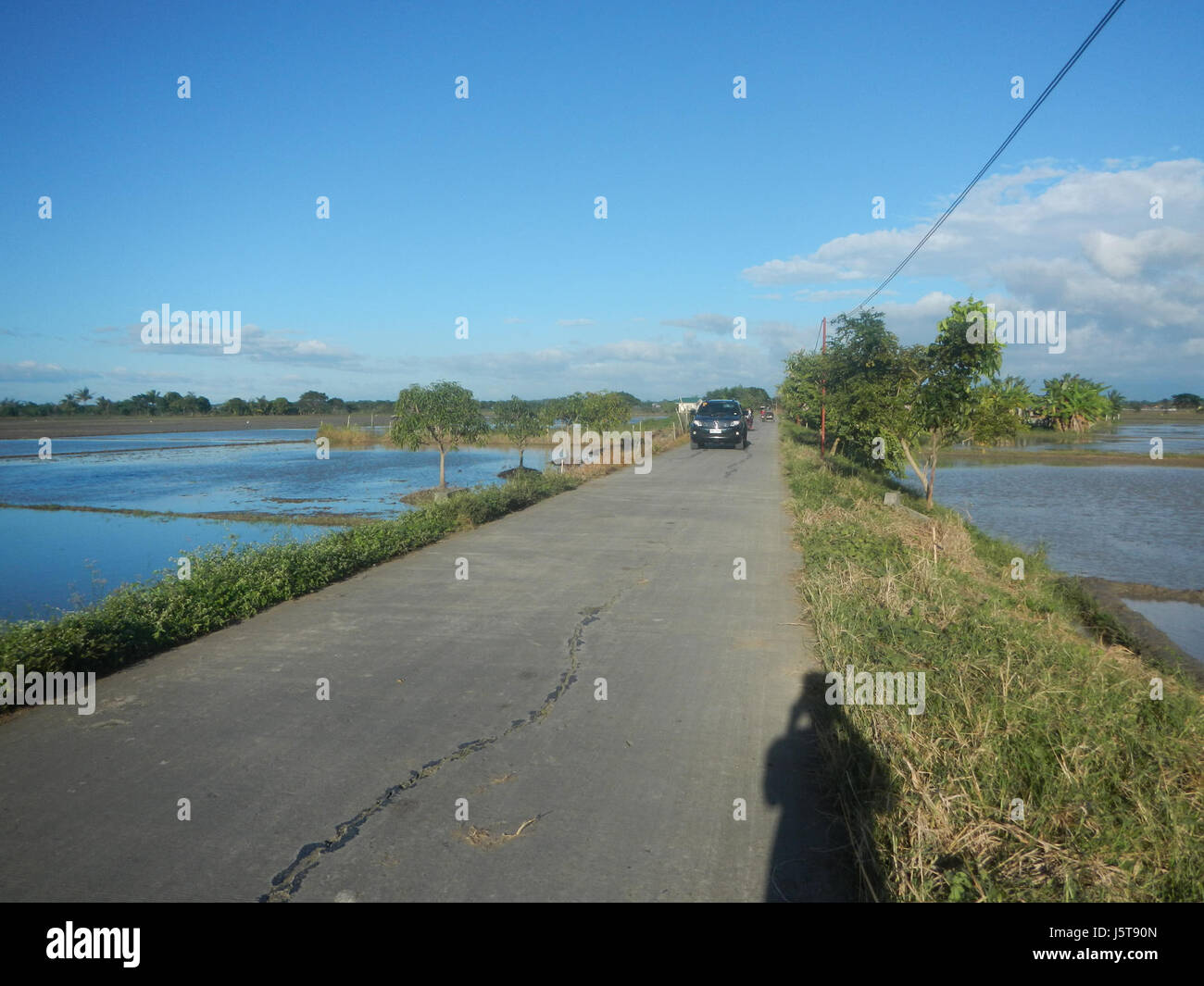 This image captures a rural scene in Concepcion, San Simon, Pampanga ...