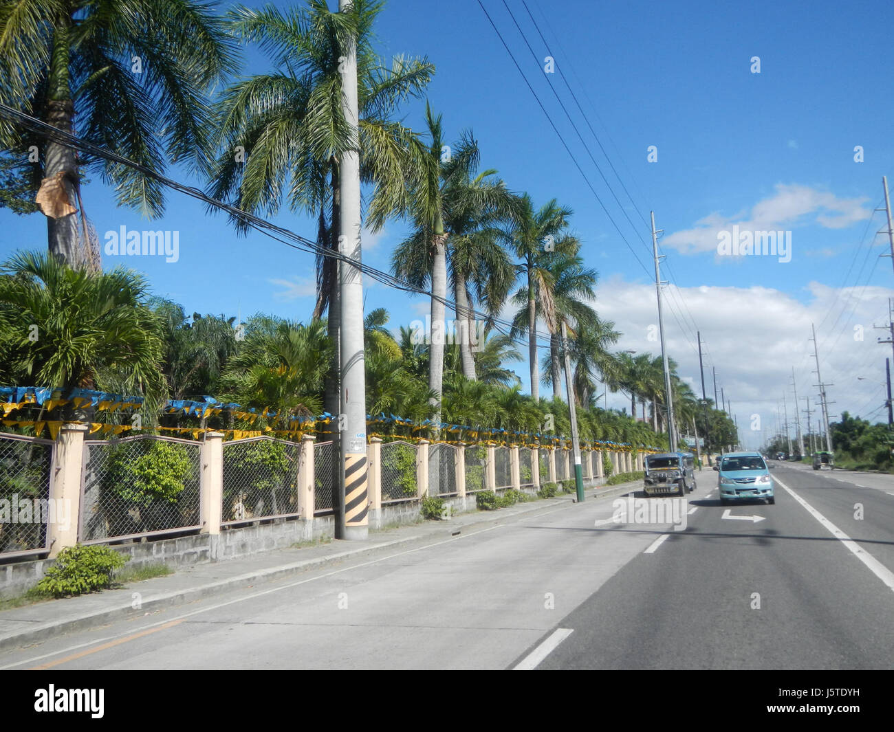 This image depicts a section of MacArthur Highway running through ...