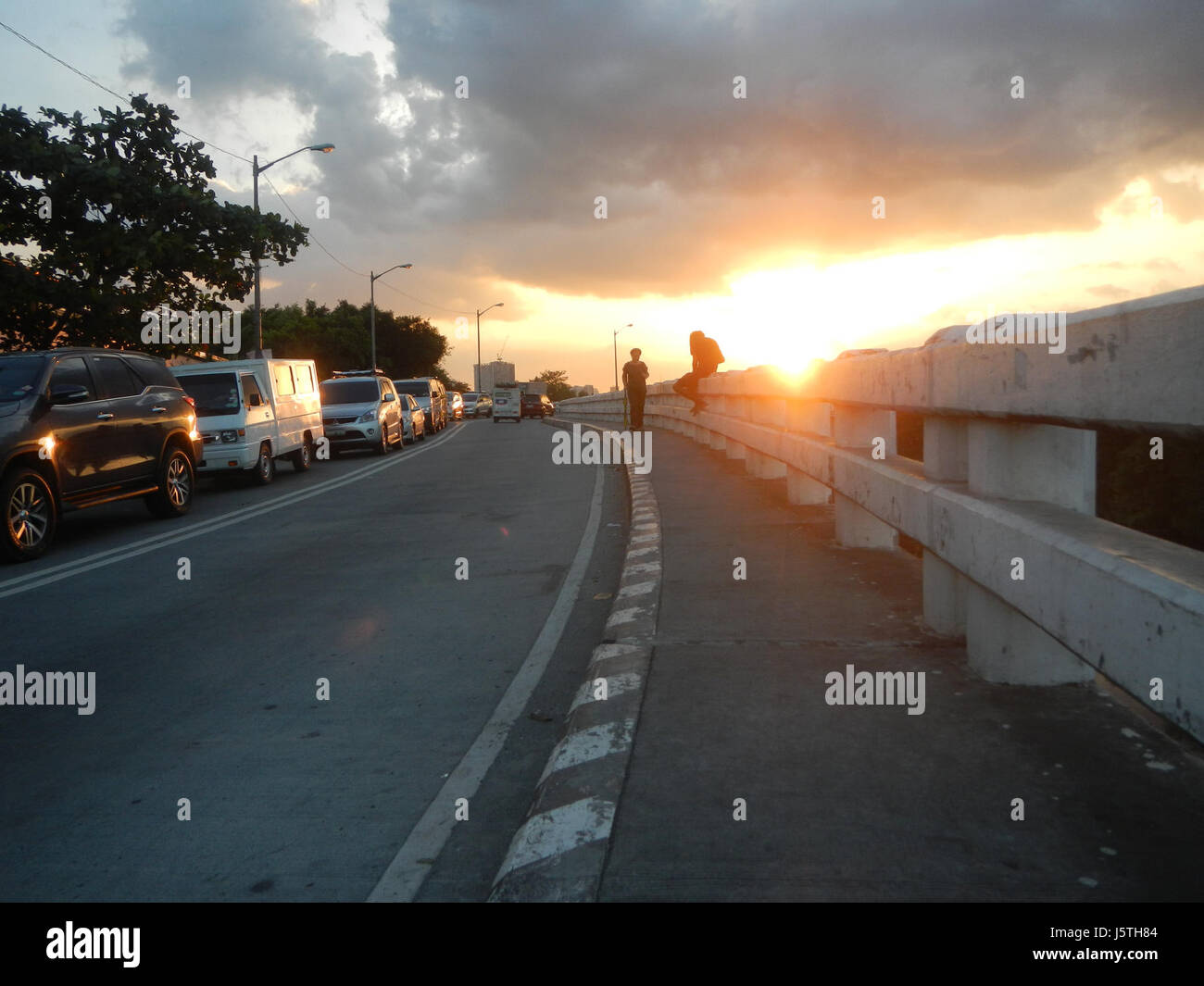 This photograph shows a sunset view over the Pasig River, with ...