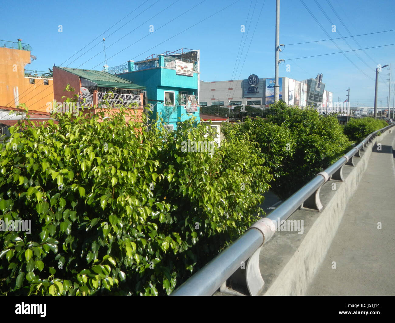 This image shows the footbridge connecting areas over Marcos Highway ...
