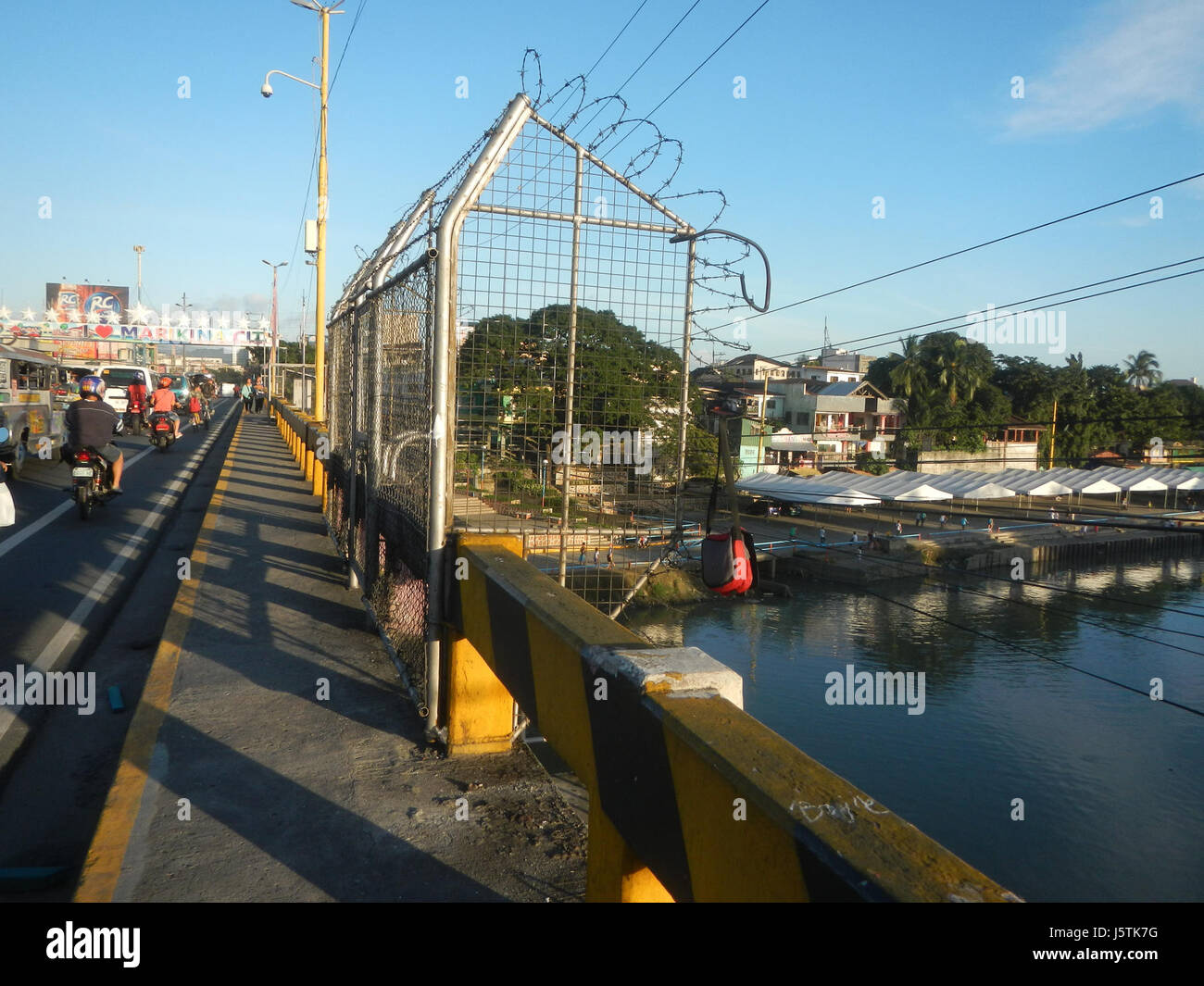 This image features a bridge spanning across the river in Marikina City ...