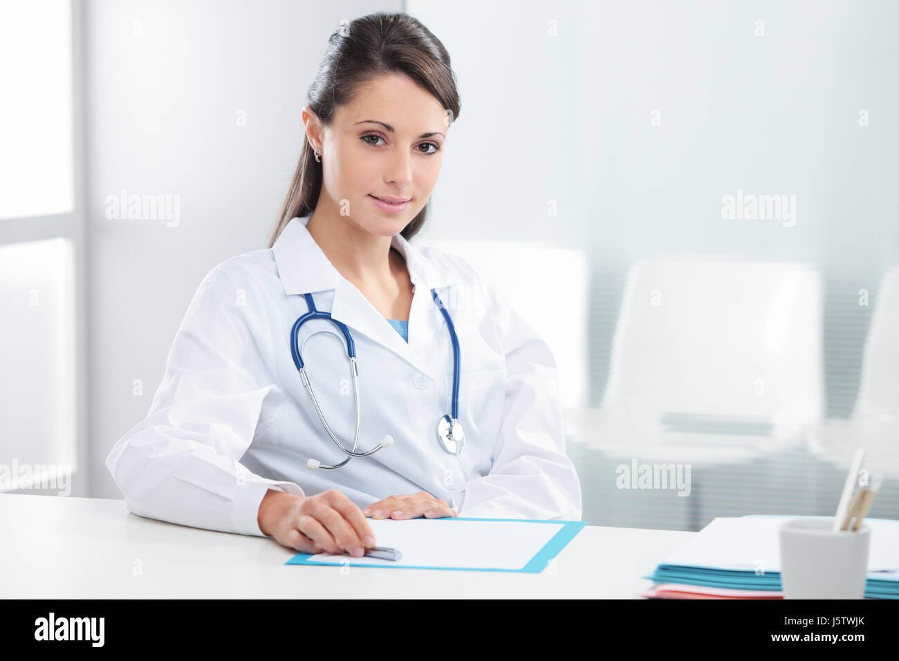Confident woman doctor sitting hi-res stock photography and images - Alamy