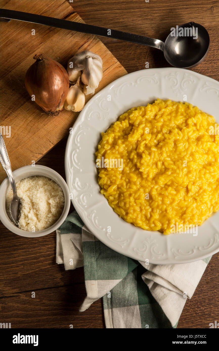 delicius Italian risotto rice with saffron on wooden background Stock ...