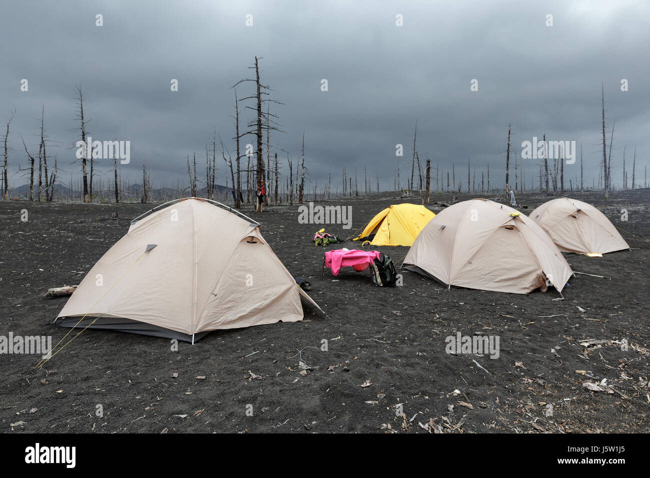 Tourist tents in Dead Wood on volcanic slag and ash eruptions Tolbachik ...