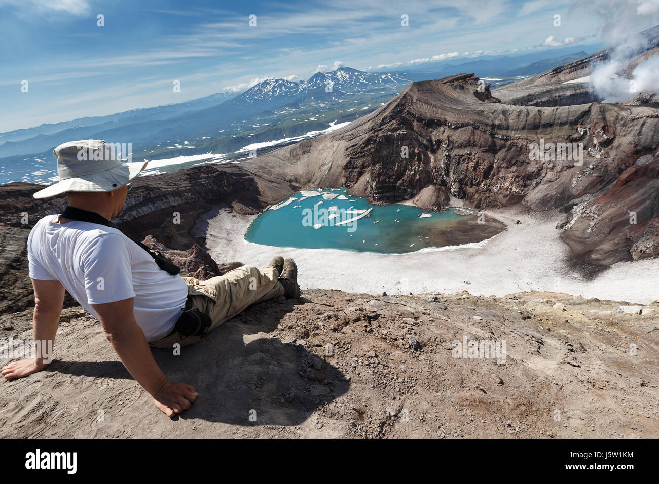 Tourists in crater of active Gorely Volcano watching at beautiful ...