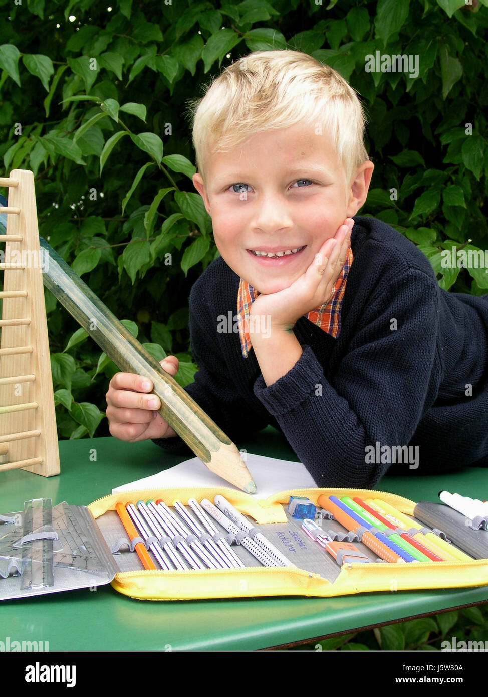 boy with pen in hand Stock Photo - Alamy