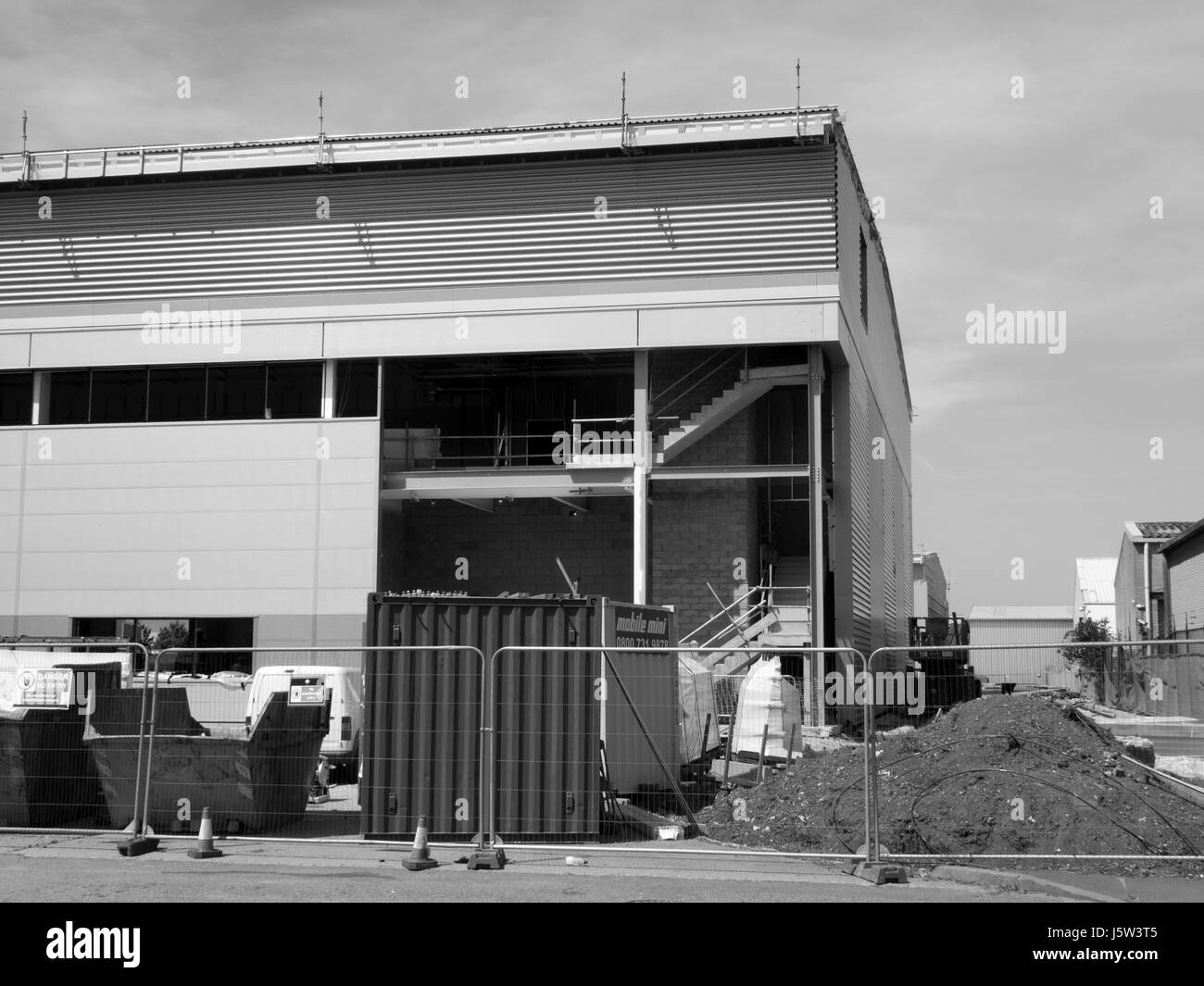 Monochrome construction site, new commercial warehouse and office ...