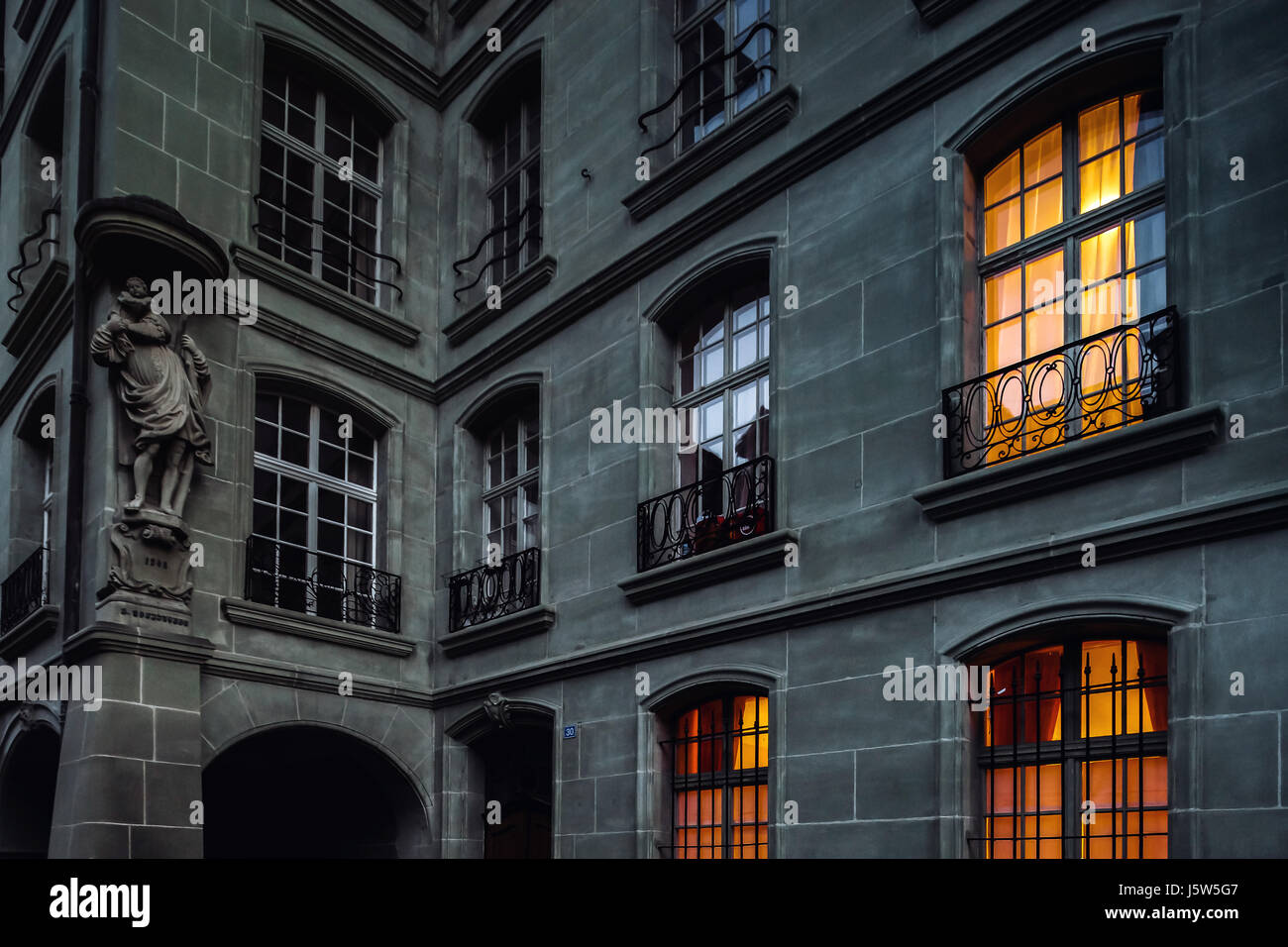 Old house with highlighted yellow windows, night view, Fribourg ...