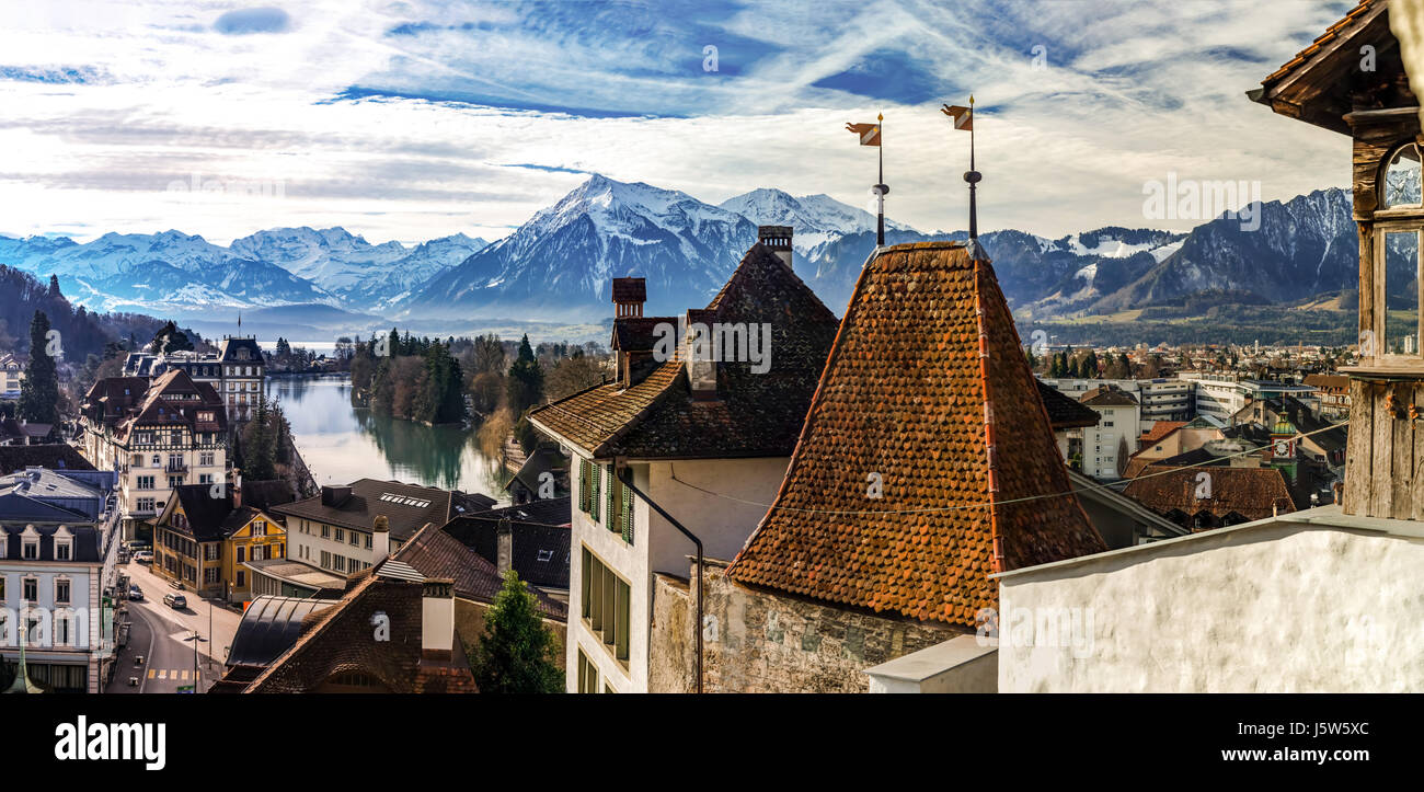 Beautiful panoramic view of Thun old city roofs and Alps on background ...