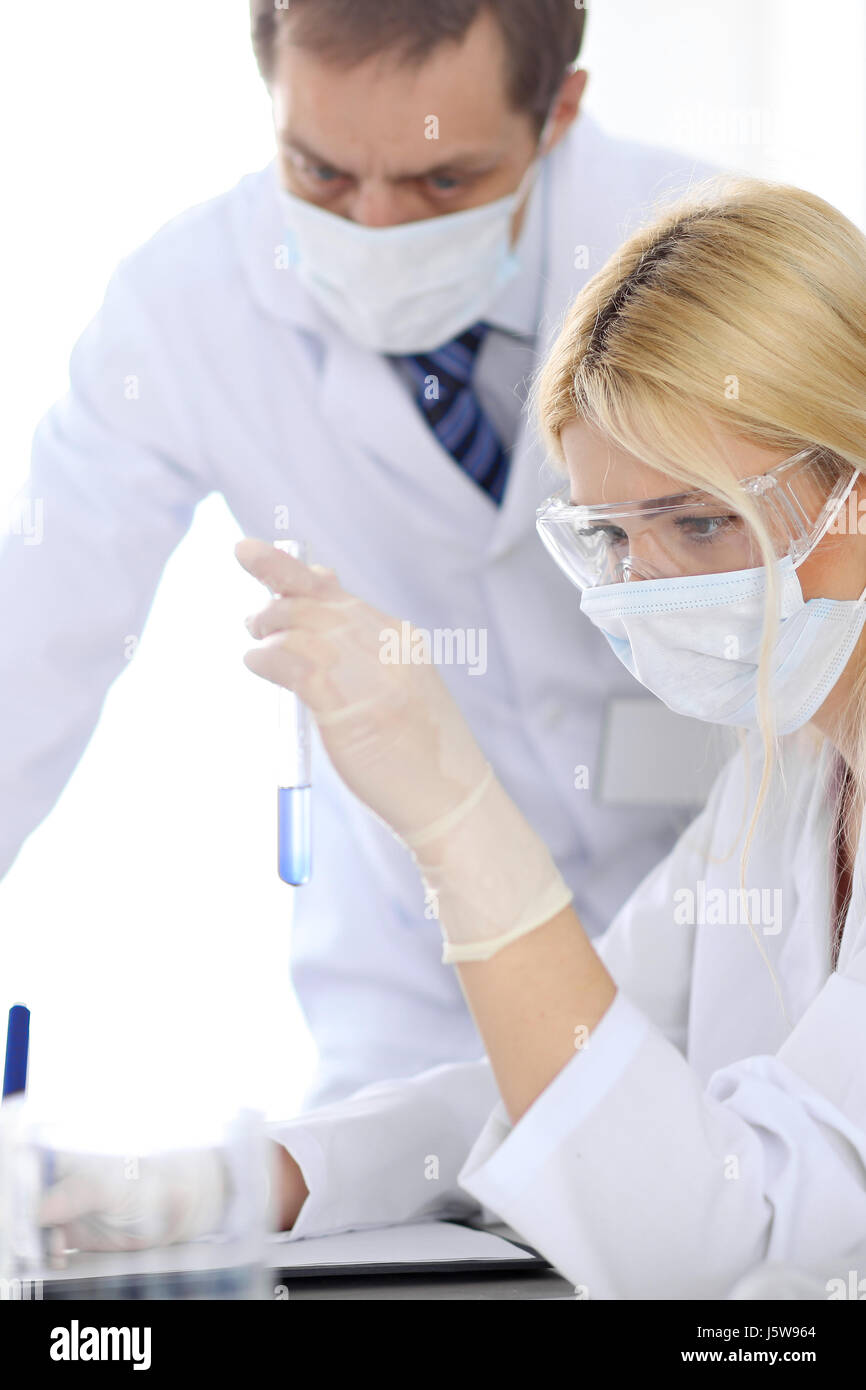 Scientific research team with clear solution in laboratory Stock Photo ...