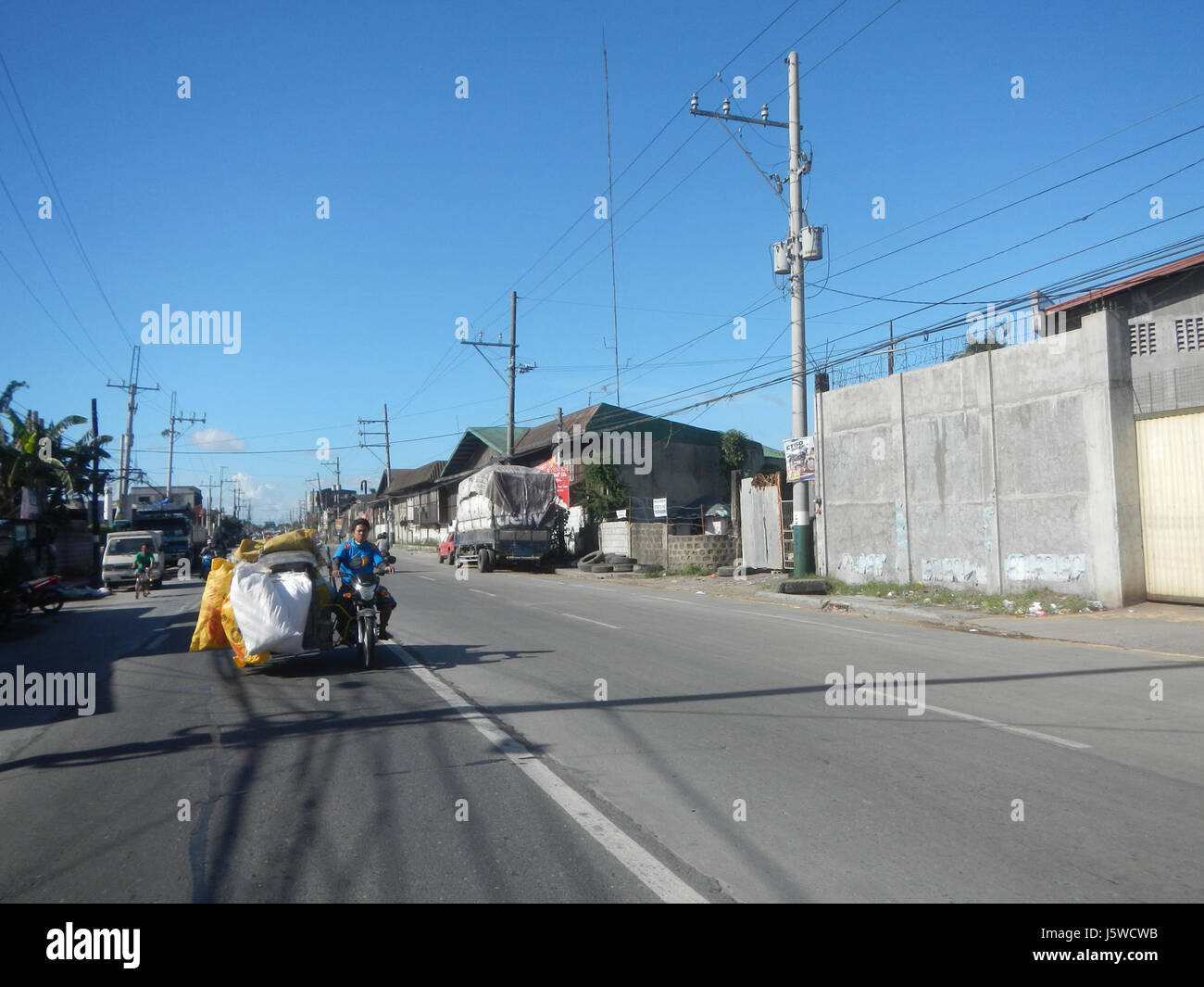 This image depicts a segment of the MacArthur Highway in the provinces ...