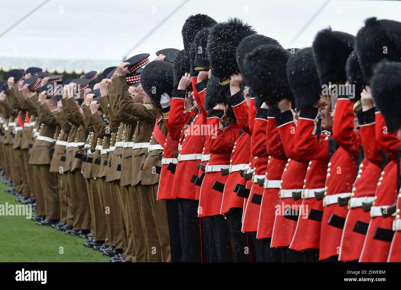Scots Guards raise their hats and bearskins while giving three cheers ...