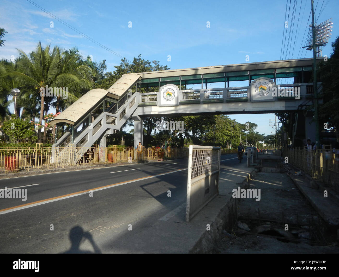 The image shows the old trees and footbridges in Makati Park Garden ...