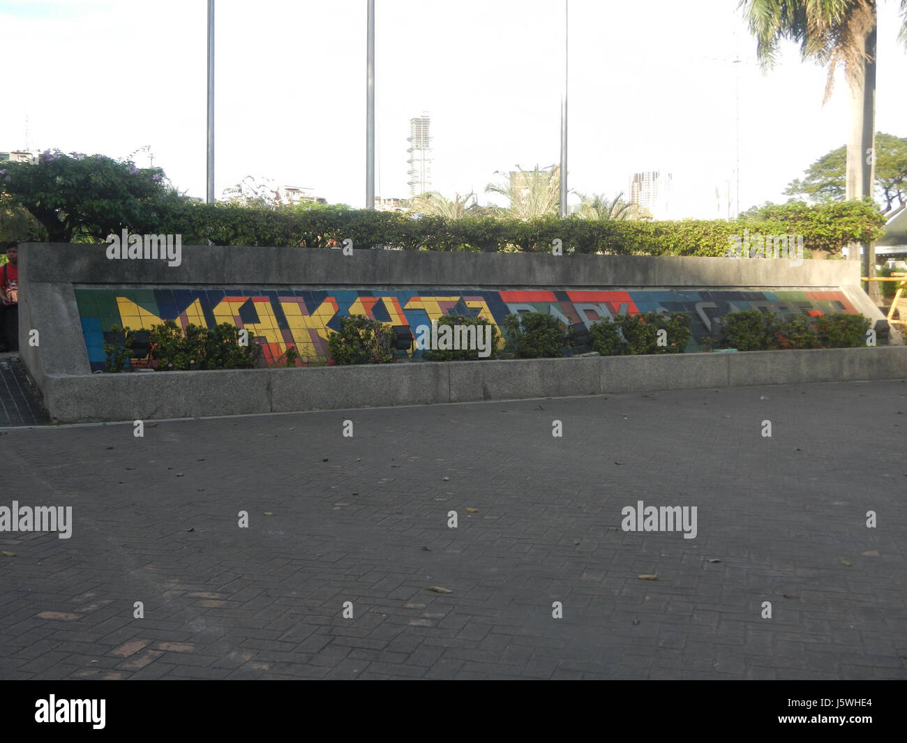 A photograph capturing the old trees and footbridges in Makati Park ...