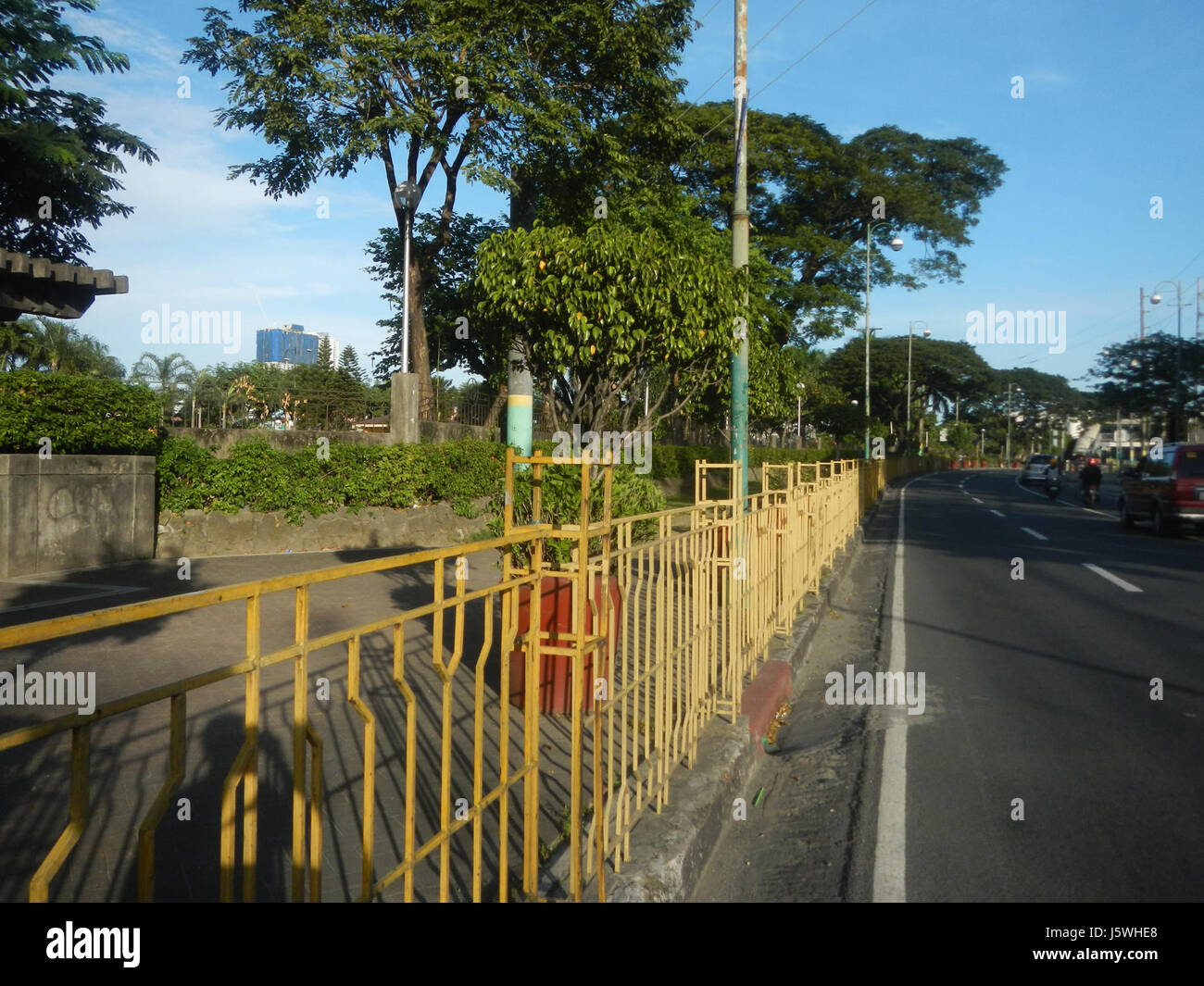 This image depicts the old trees and footbridges within Makati Park ...