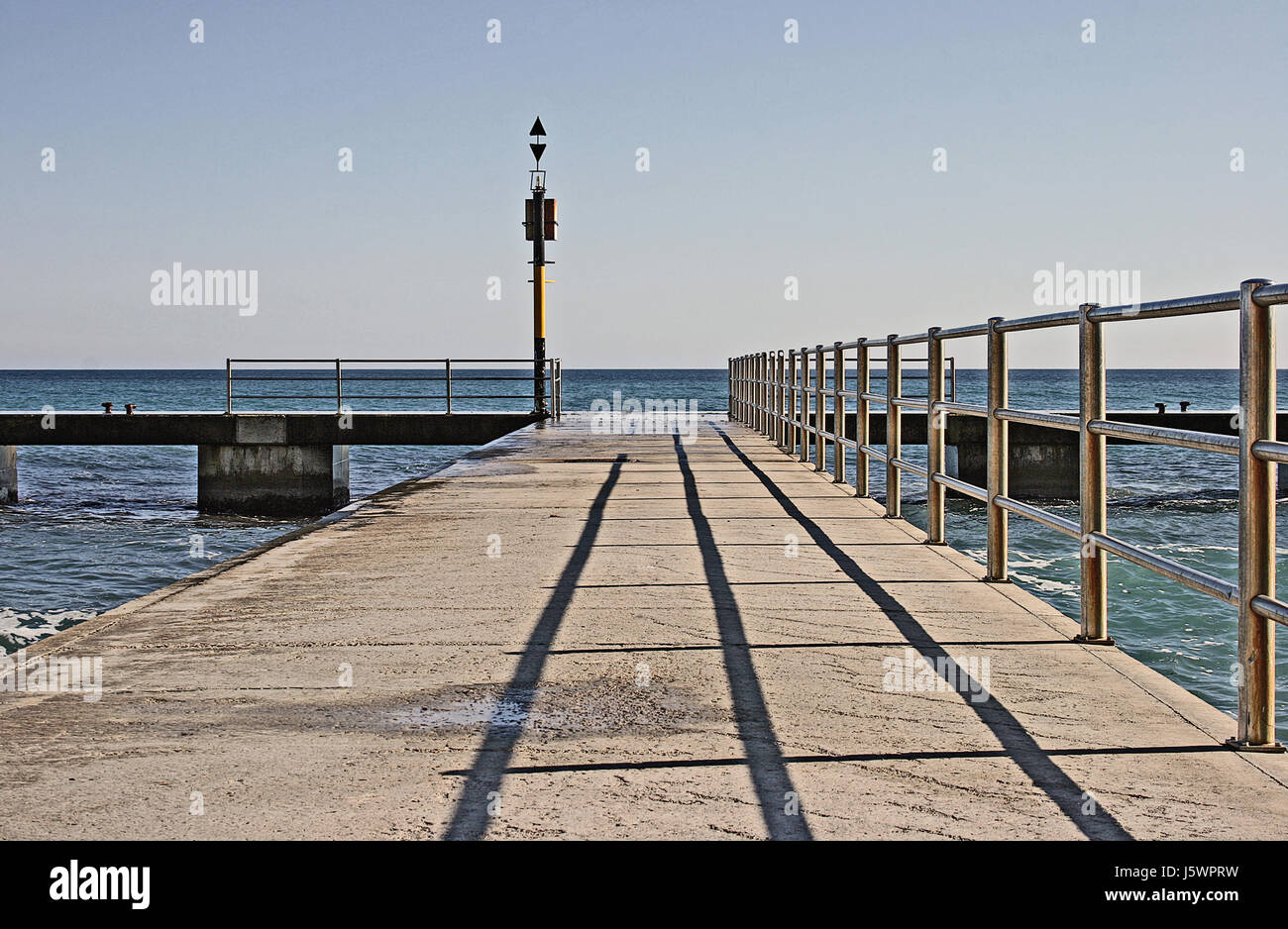 bridge railing path way salt water sea ocean water shaddow shadow ...