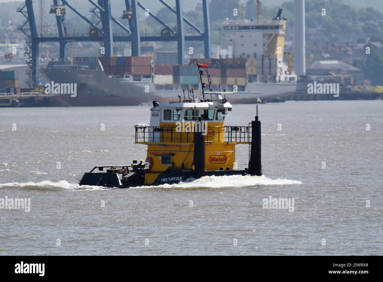 A tug operating near Tilbury Docks on the River Thames in Essex, UK ...