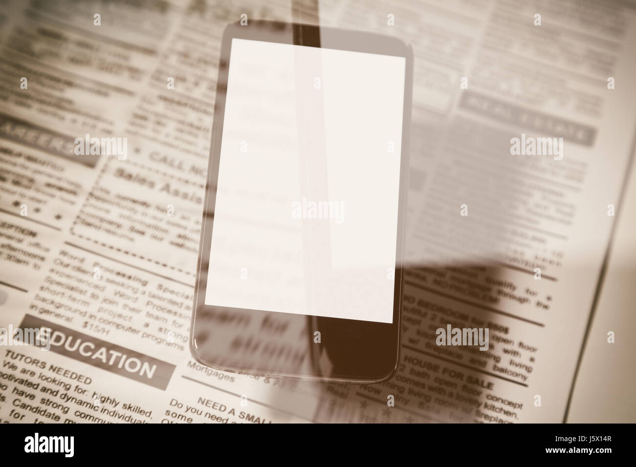 Fake newspaper and smartphone with blank screen. business communication ...