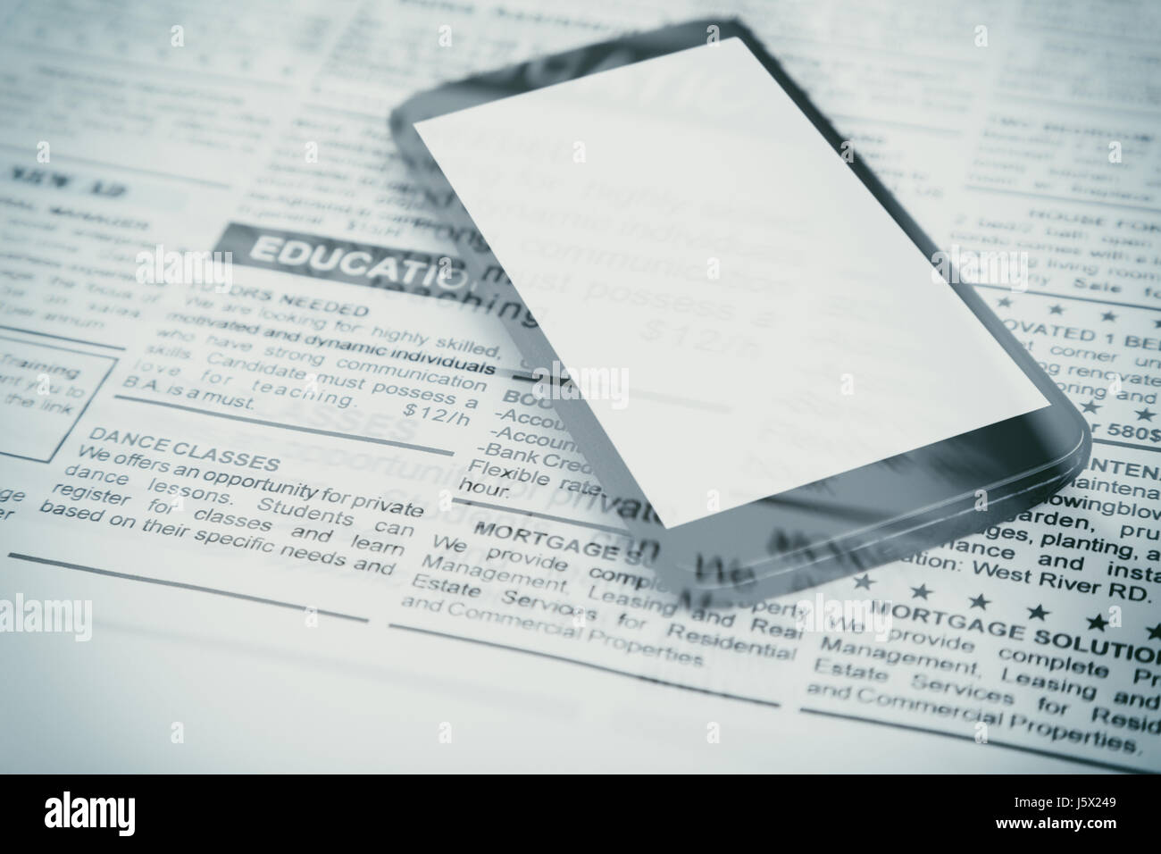 Fake newspaper and smartphone with blank screen. business communication ...