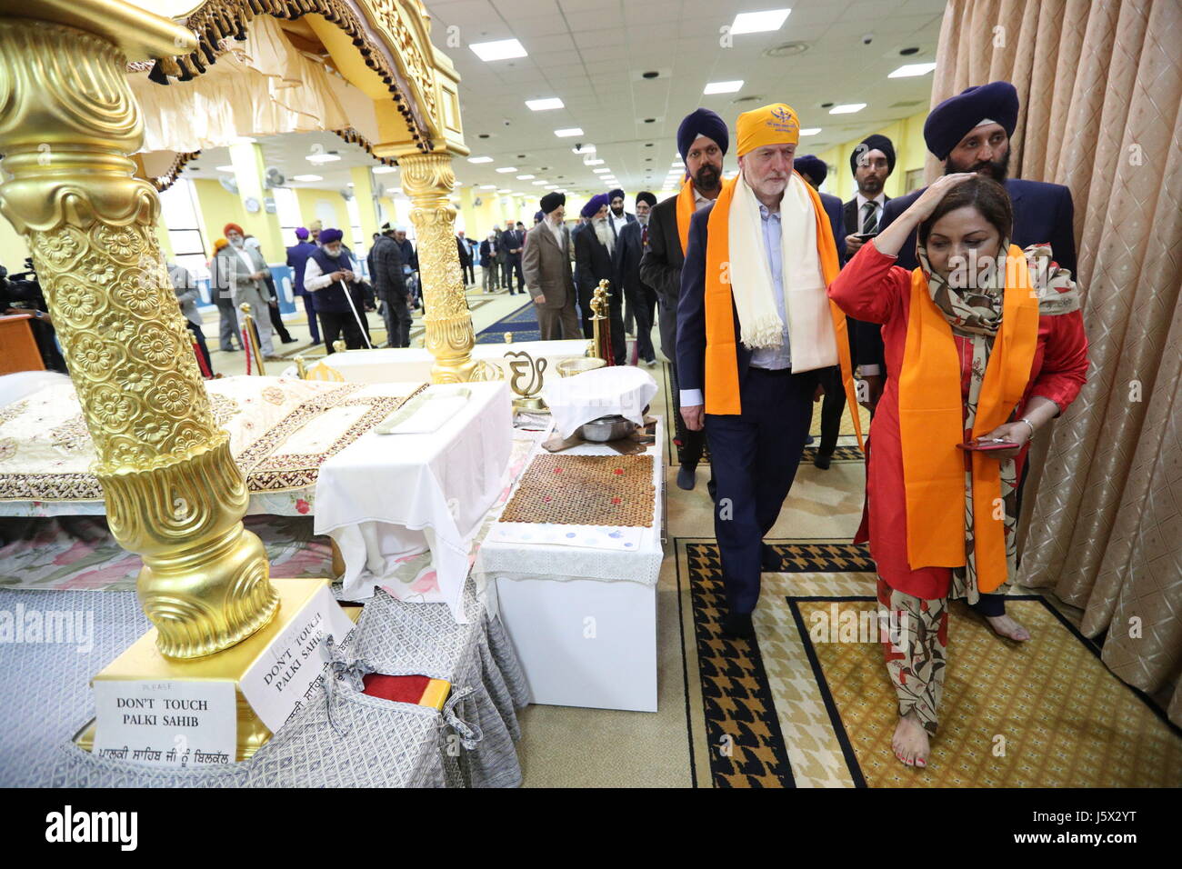 Labour leader Jeremy Corbyn wears a turban and siropa as he walks past ...