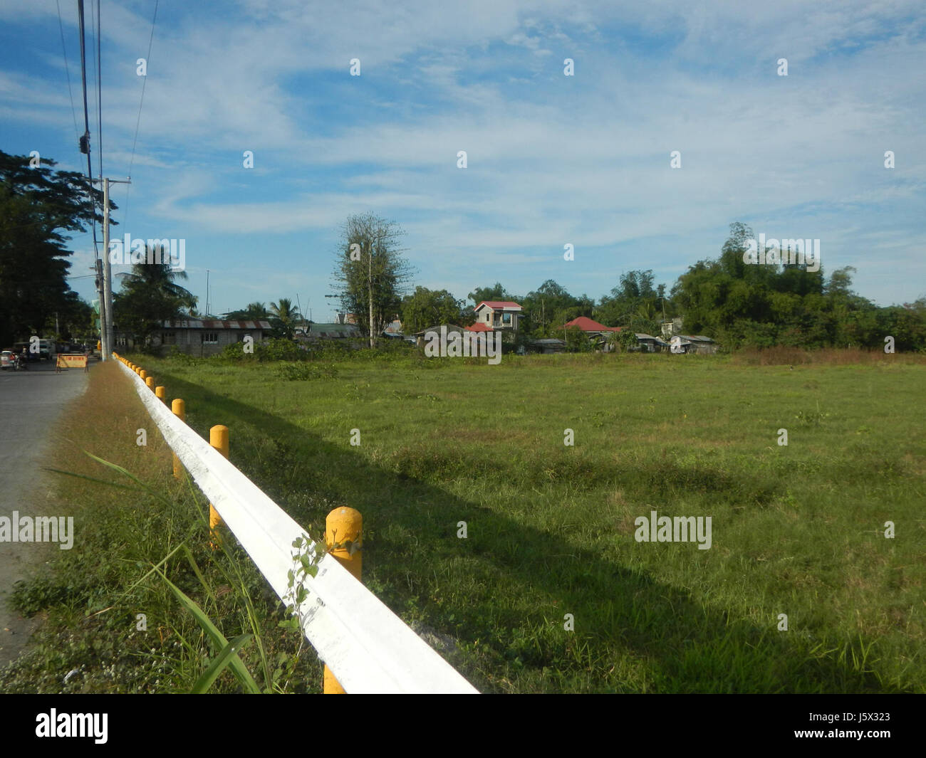 A photograph of paddy fields and grasslands in Sumacab Sur Norte ...