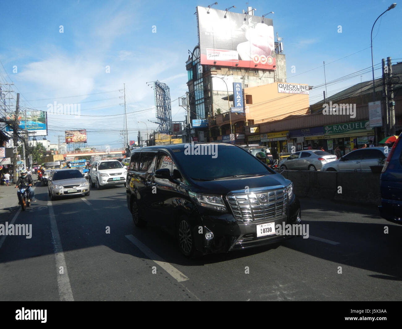 This image shows the bustling intersection of Amang Rodriguez Avenue ...