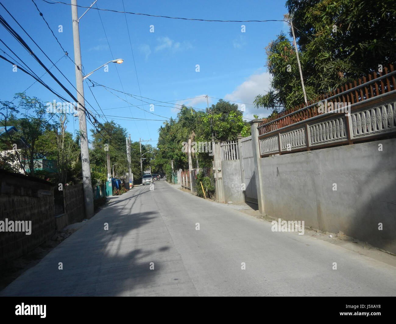 A rural farm-to-market road located in the San Vicente Agustin, Batasan ...