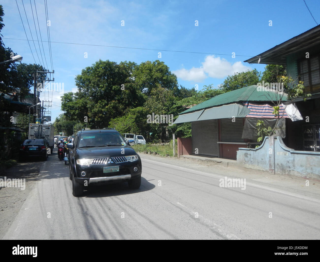 This image depicts a road in the Philippines, connecting various areas ...
