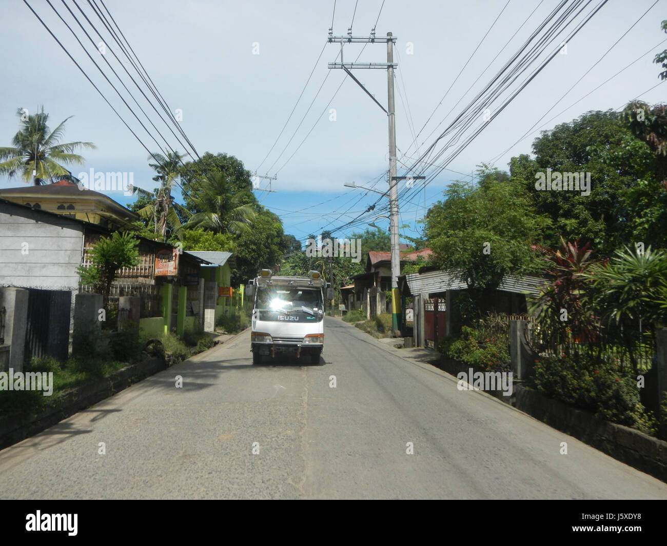 This image showcases the rural roads and agricultural land of Poblacion ...