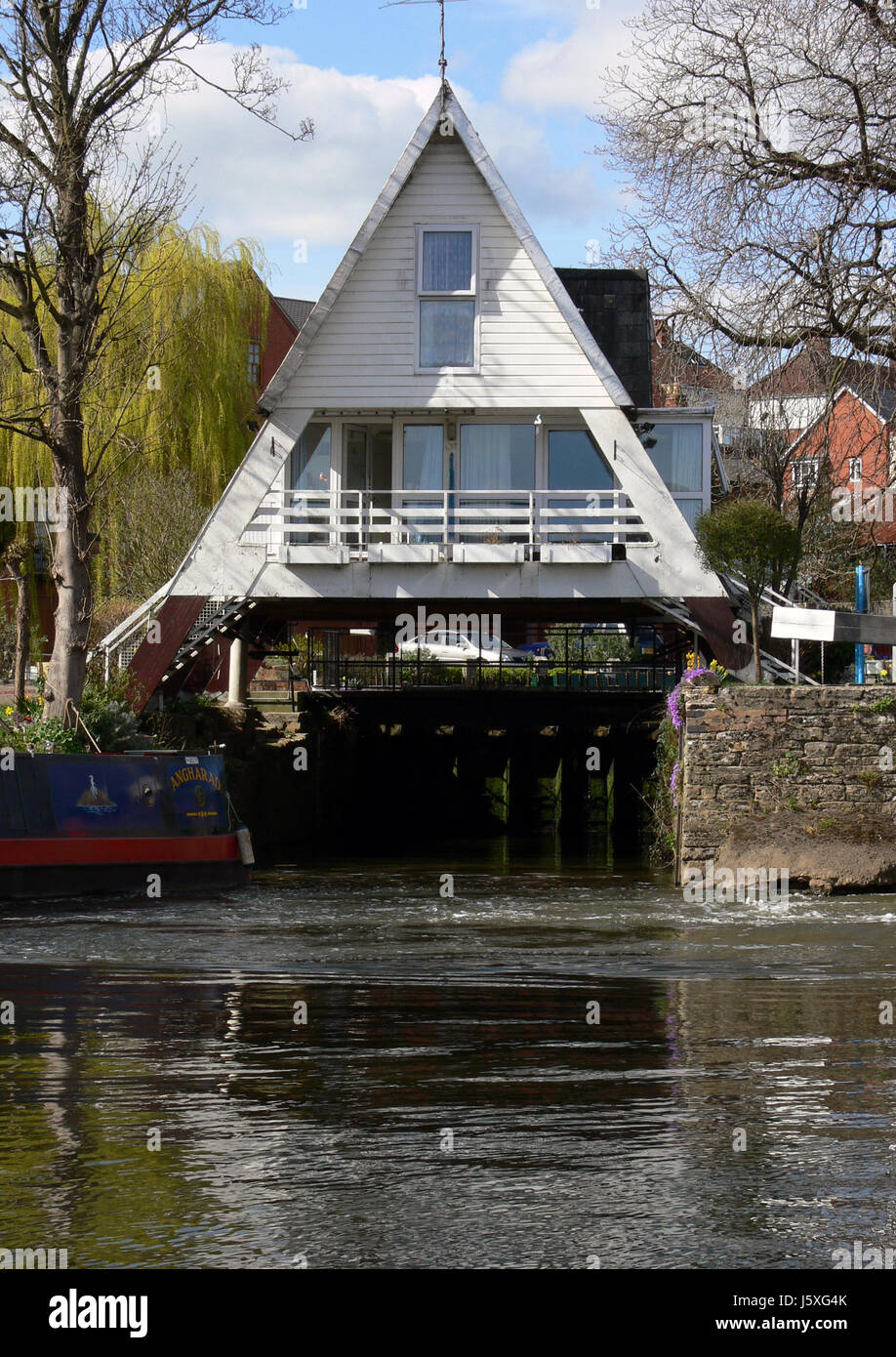 house building over stream boat lock barge canal river water rowing ...