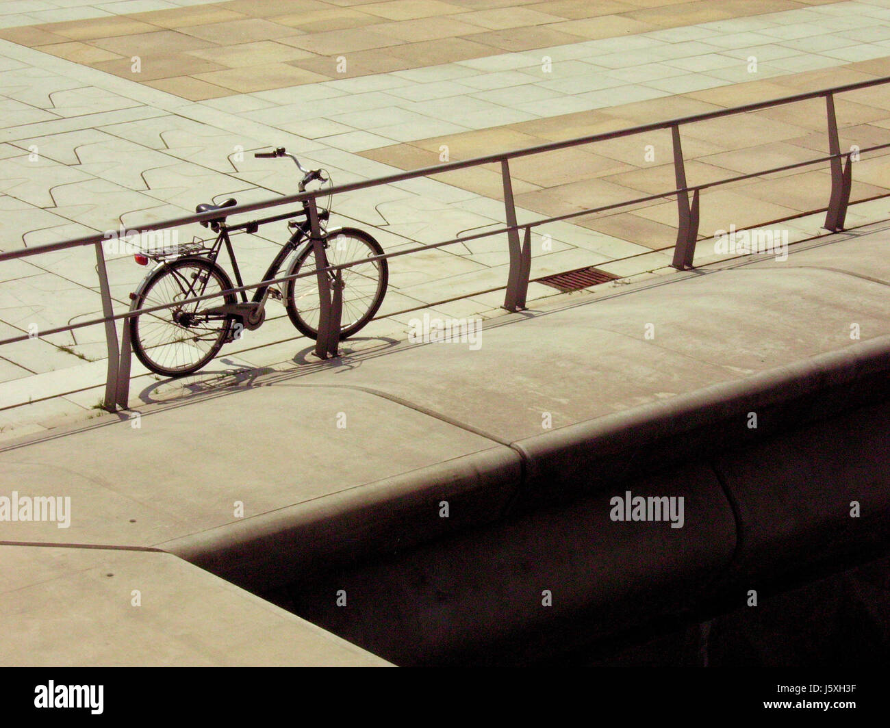 bicycle against a railing Stock Photo - Alamy