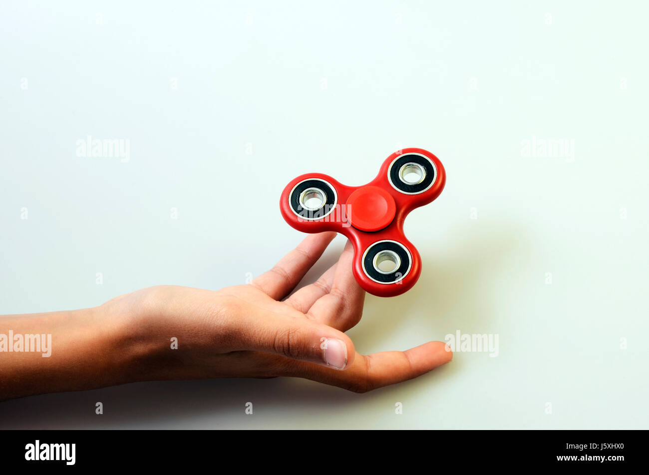 red Hand spinner, fidgeting hand toy Stock Photo - Alamy red Hand spinner, fidgeting hand toy Stock Photo - Alamy