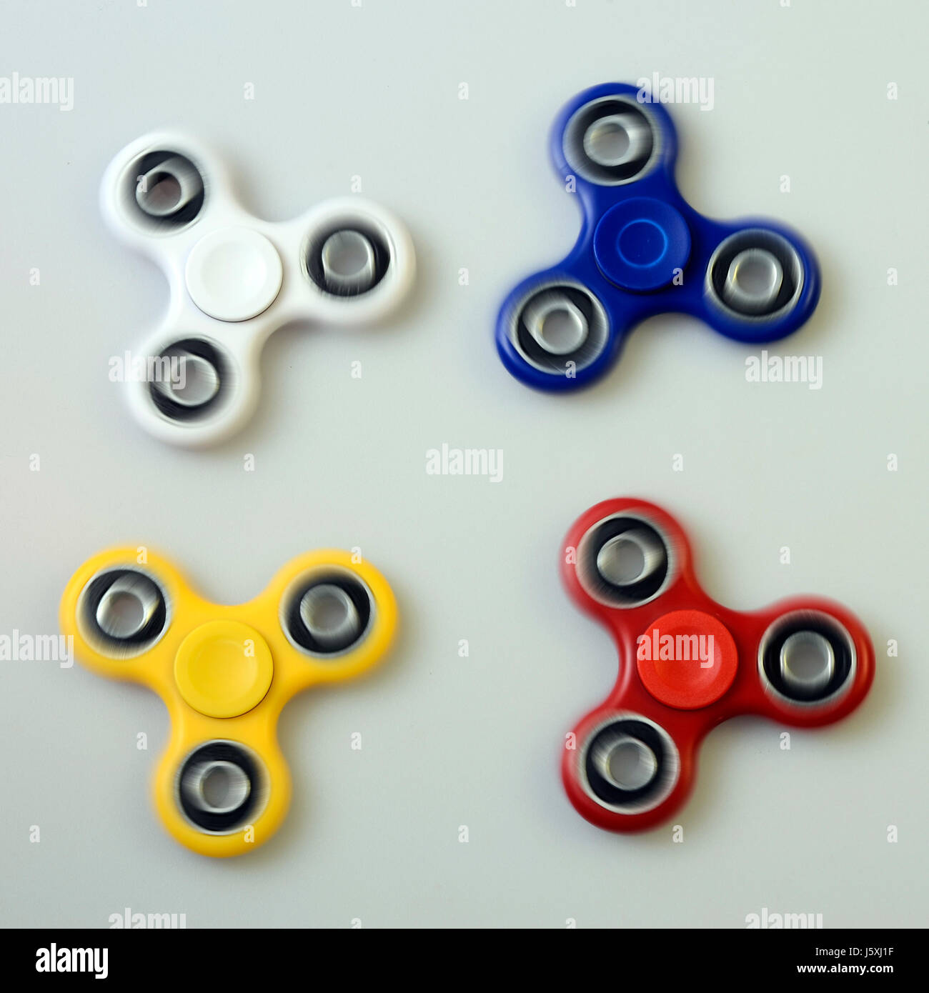 Four colored Hand spinner, fidgeting hand toy rotating Stock Photo - Alamy Four colored Hand spinner, fidgeting hand toy rotating Stock Photo - Alamy