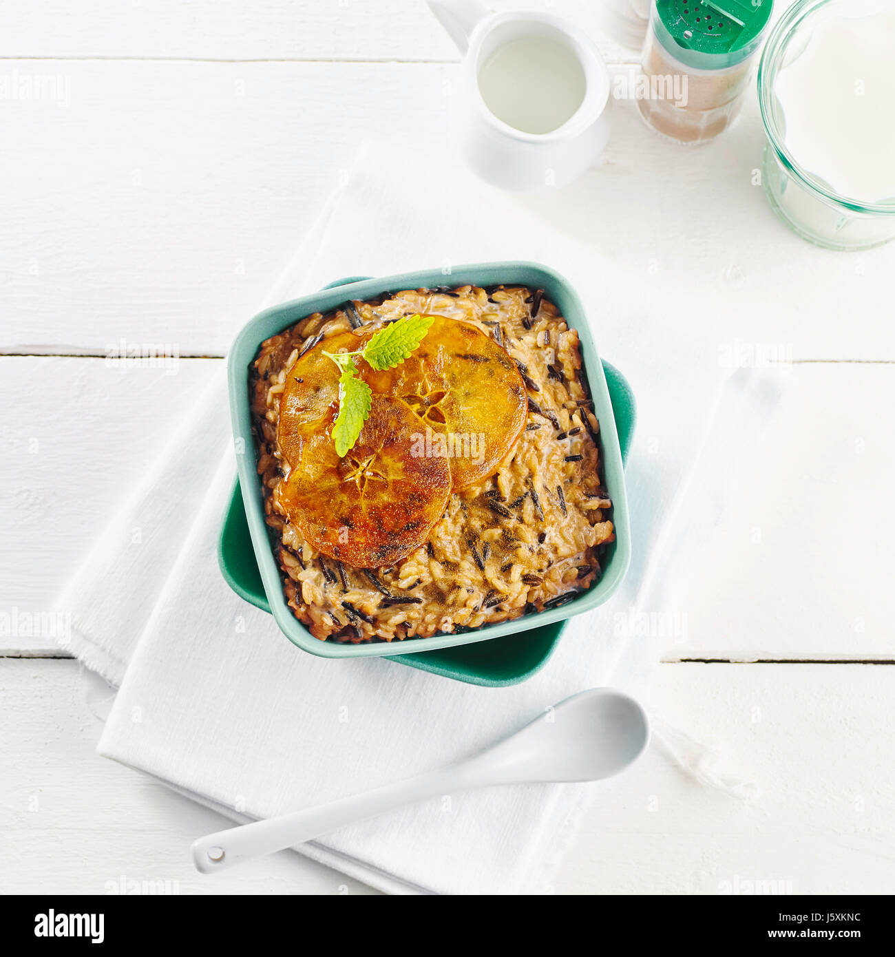 Milk rice with caramelized apple slices Stock Photo - Alamy