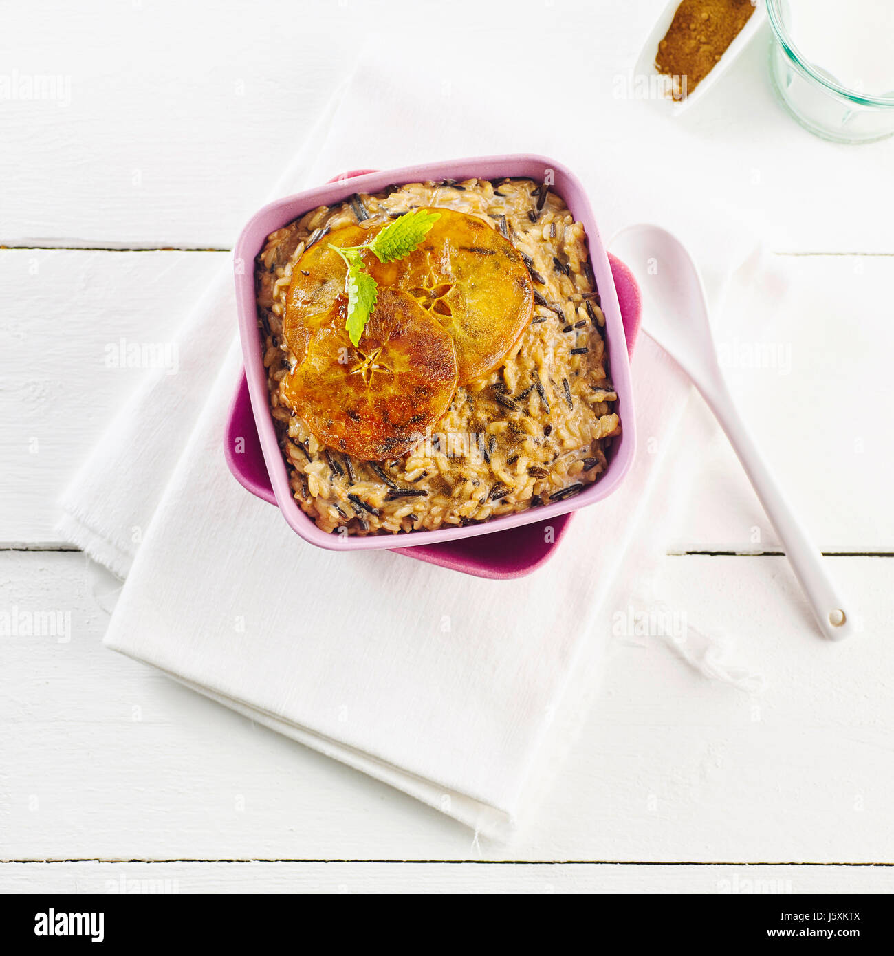 Milk rice with caramelized apple slices Stock Photo - Alamy