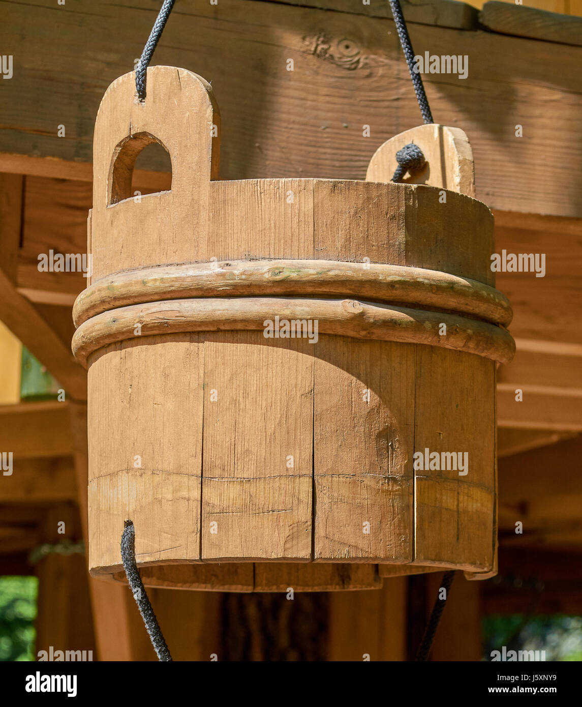 Wooden bucket with rope handle on the background Stock Photo - Alamy