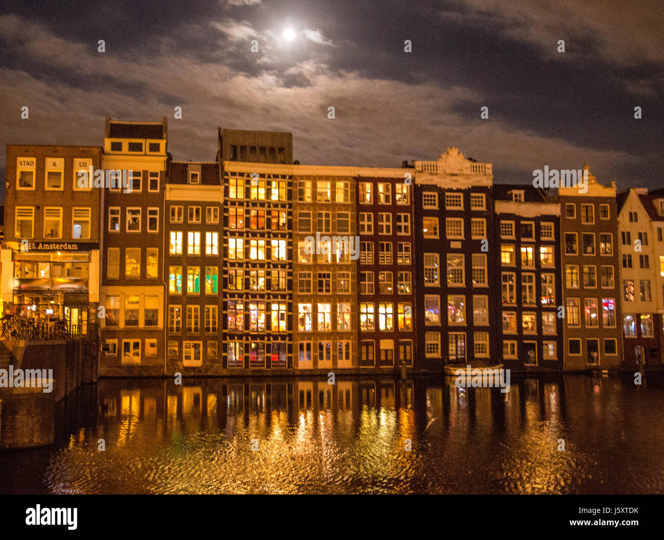 Full moon over the lit up Amsterdam canals and houses at night, with ...
