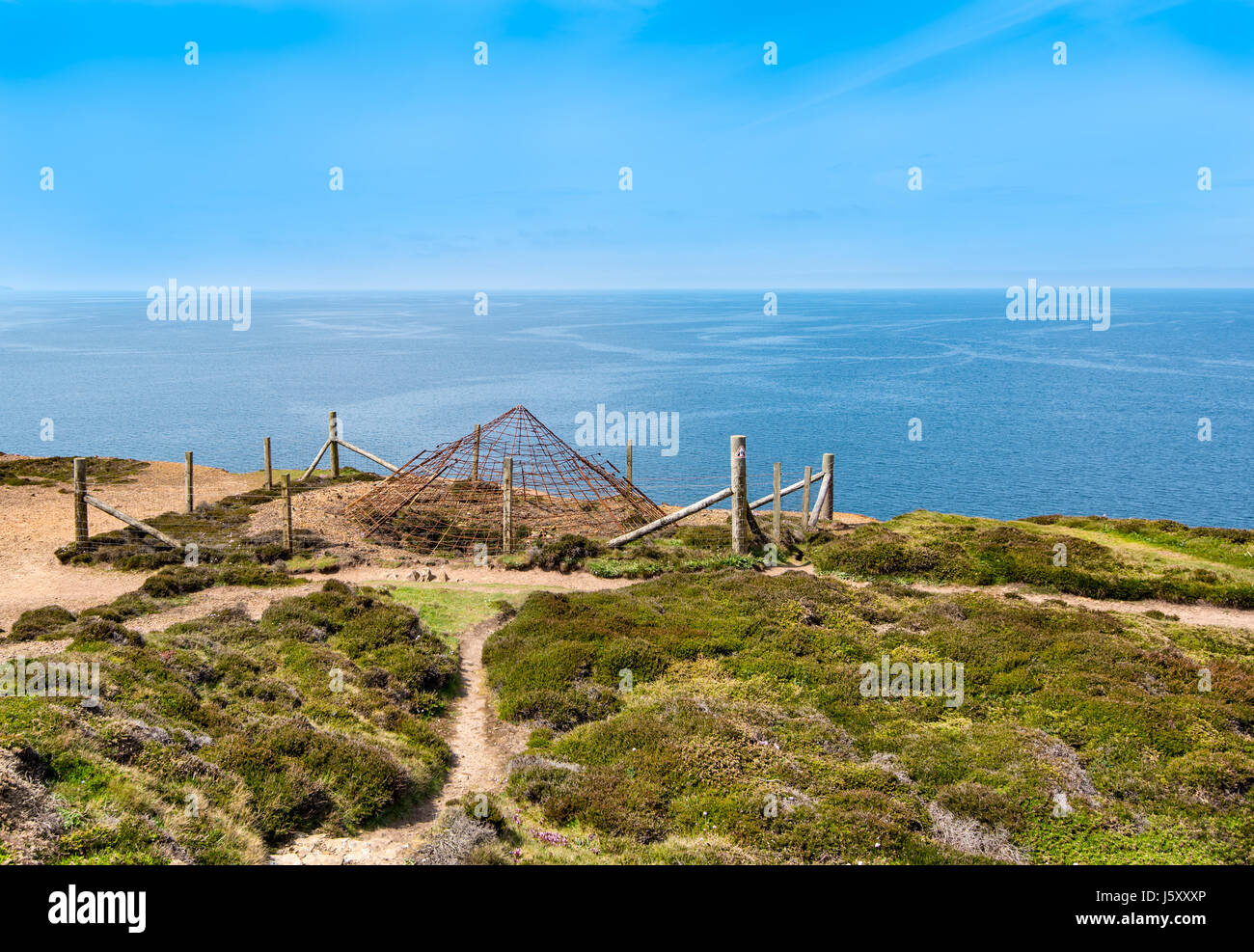 Open mineshaft near to the Cornish Coast Footpath, protected by a ...
