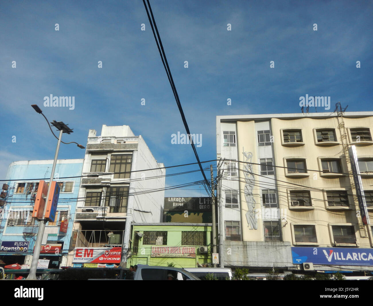 A photograph showcasing the buildings in the Quiapo district of Manila ...
