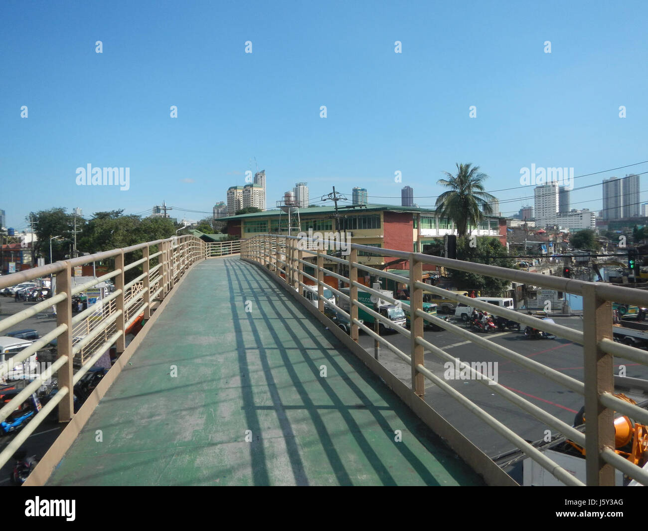 A photograph of a pedestrian footbridge located near AMA ACLC, Puregold ...