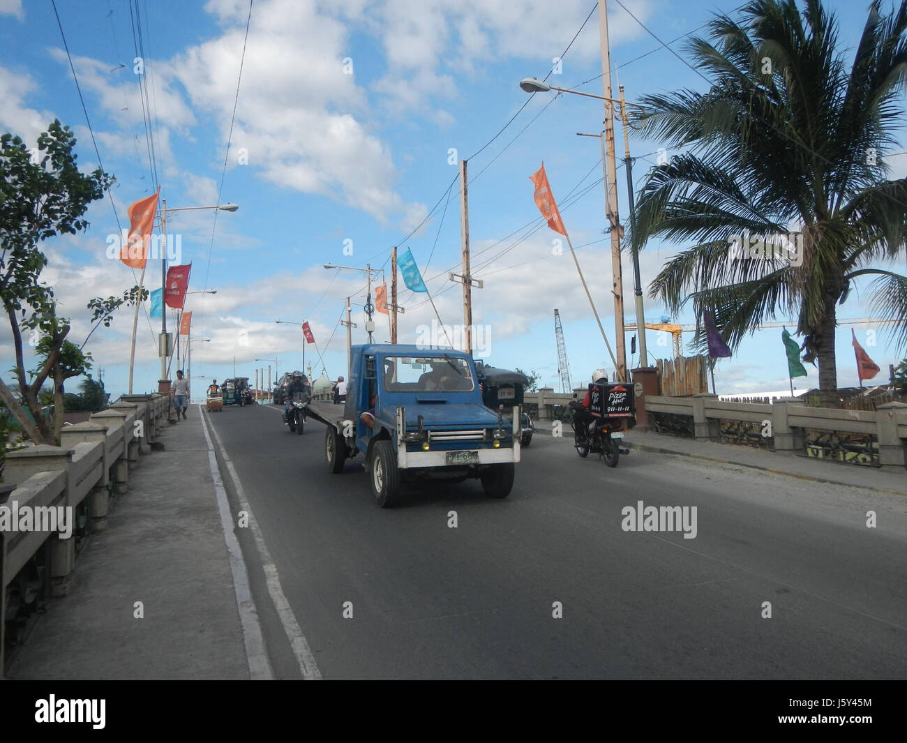 This image depicts the Kalawaan Bambang Bridge, spanning the river in ...