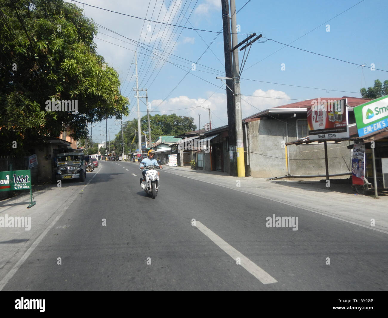 This rural scene from Malolos, Bulacan, Philippines, depicts a view of ...
