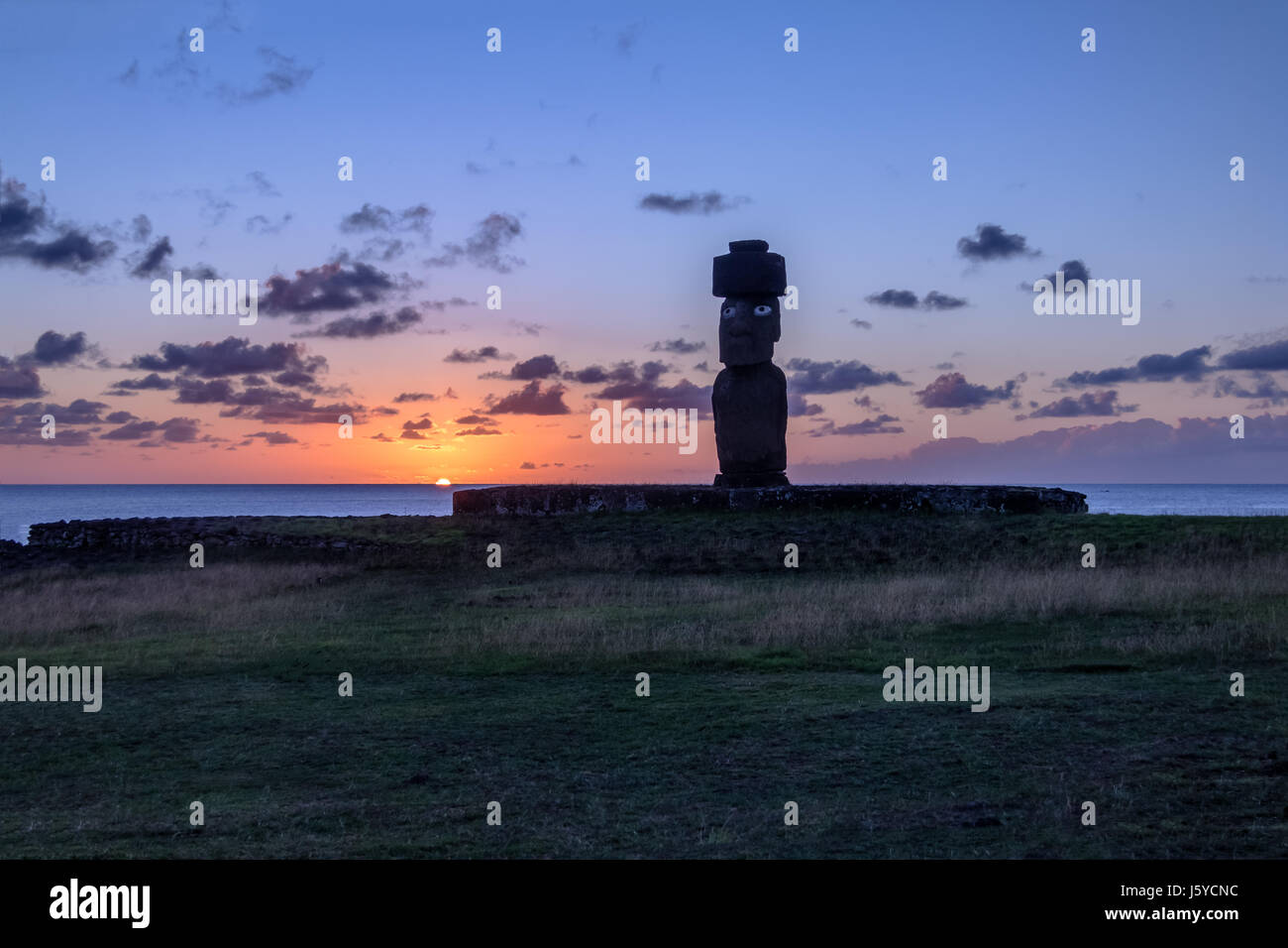 Ahu Tahai Moai Statue wearing topknot with eyes painted at sunset near ...